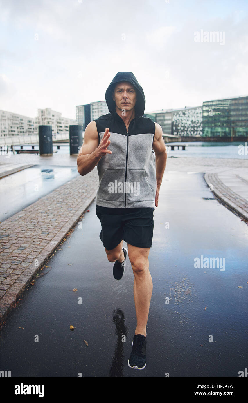 Man running in rain hi-res stock photography and images - Alamy