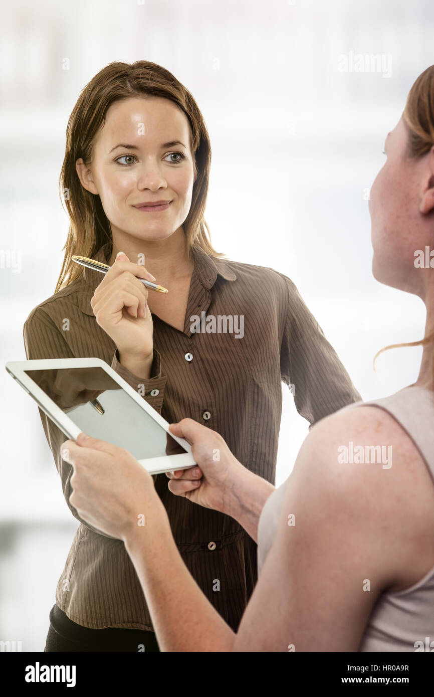 two happy business woman working together Stock Photo - Alamy