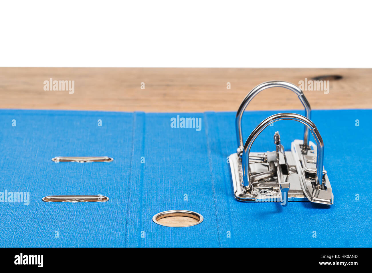 Empty open blued folder for papers with a metal clip, lying on a wooden ...