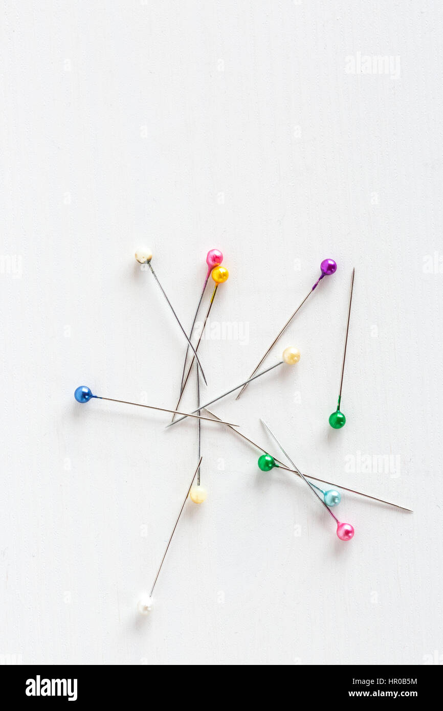 color pins for sewing on a white background, top view Stock Photo - Alamy