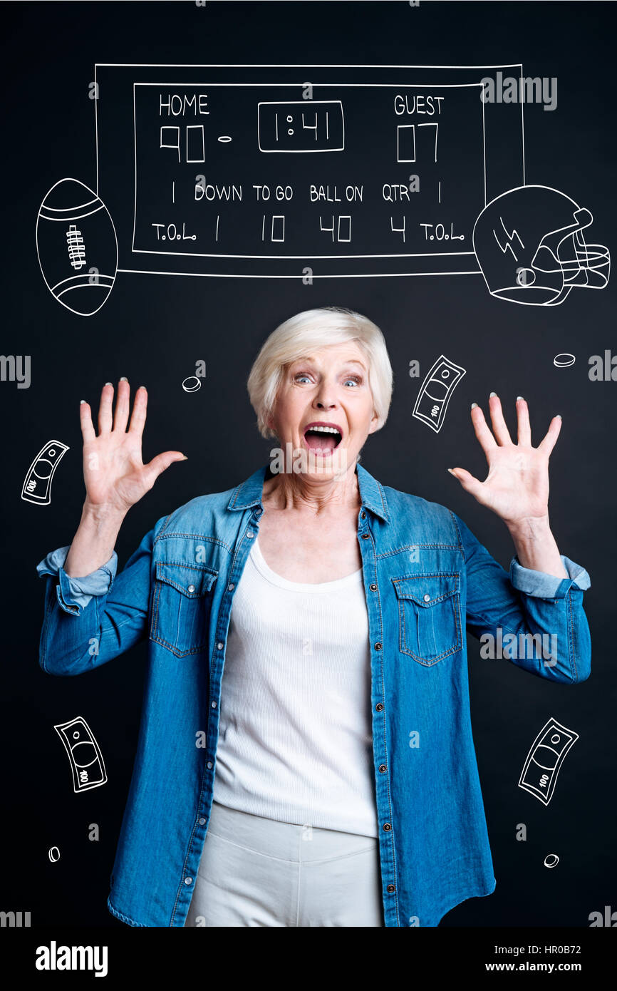 Winning score. Joyful delighted aged woman guessing the right score and ...
