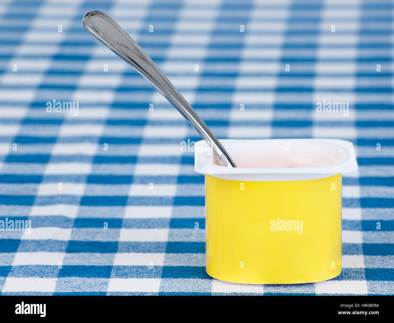 yogurt pot with spoon isolated on white background Stock Photo - Alamy