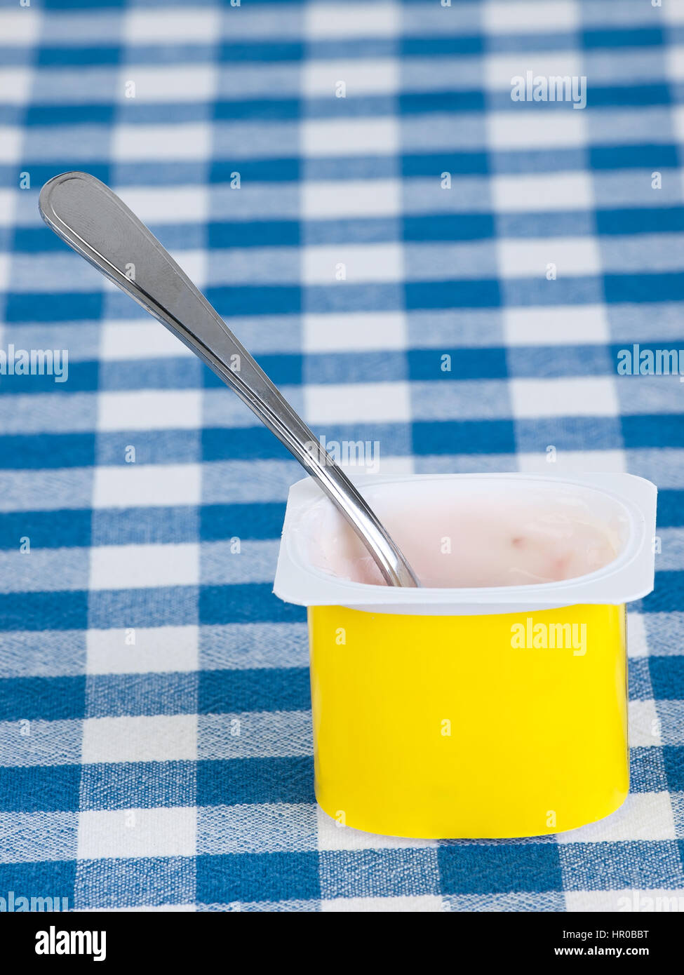 yogurt pot with spoon isolated on white background Stock Photo - Alamy