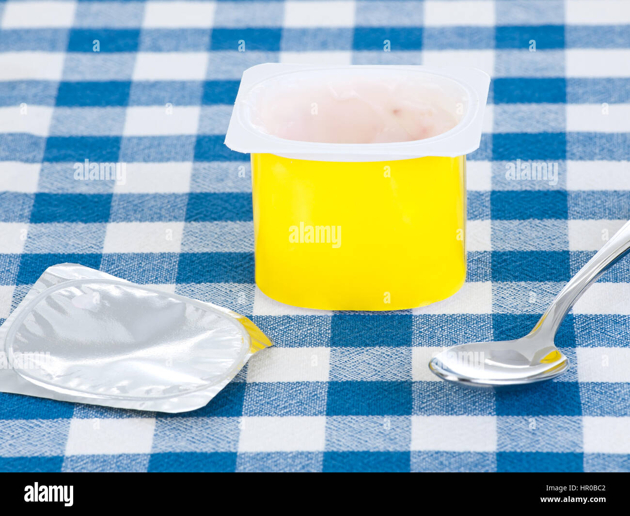 yogurt pot with spoon isolated on white background Stock Photo - Alamy