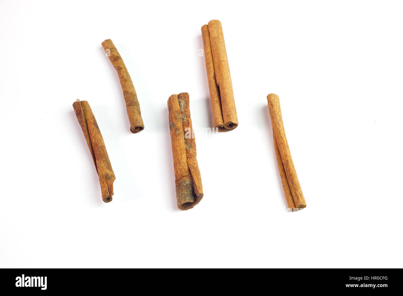 Row of cinnamon sticks isolated on a white background Stock Photo - Alamy