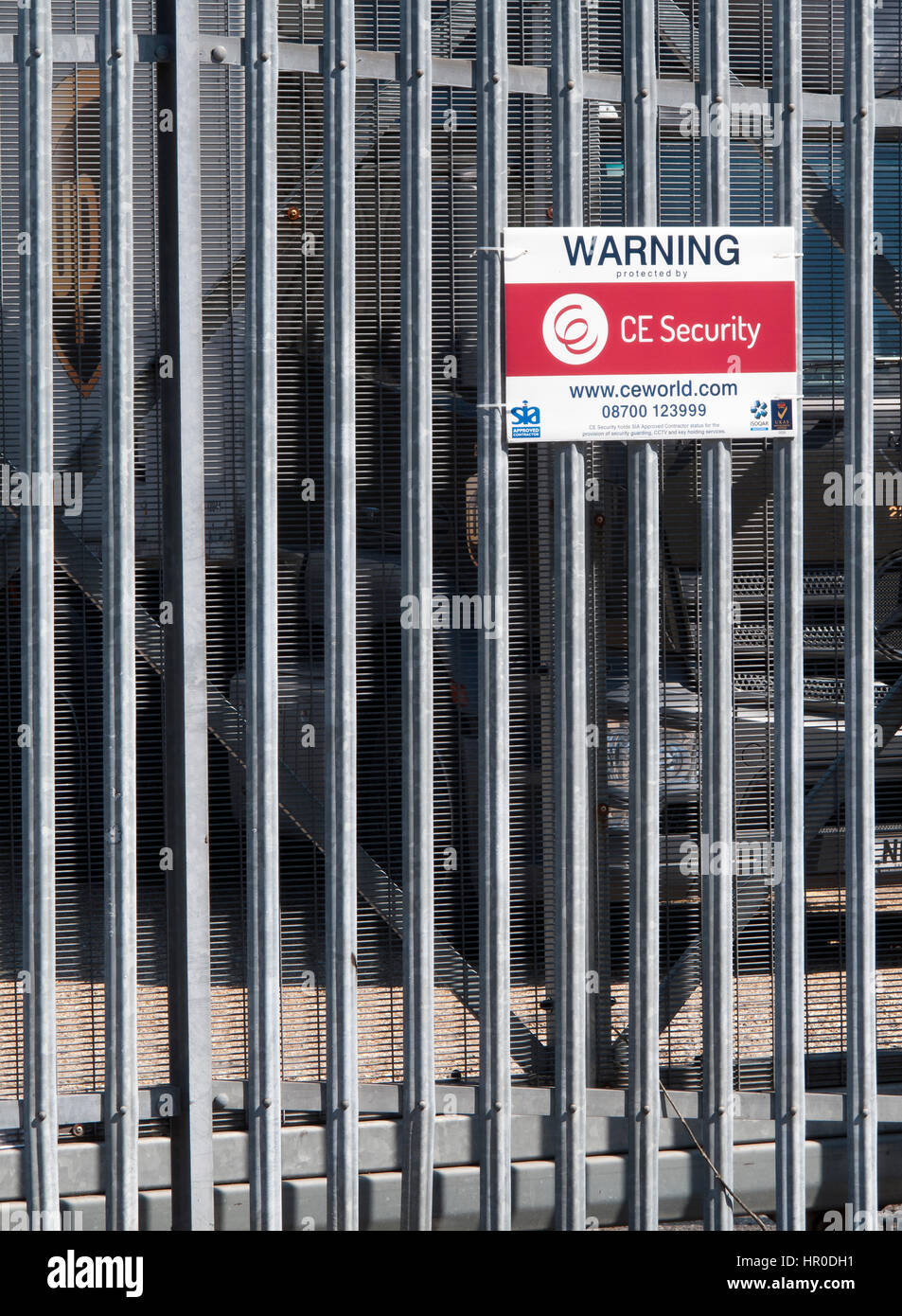 Warning security sign on perimeter boundary fence Stock Photo - Alamy