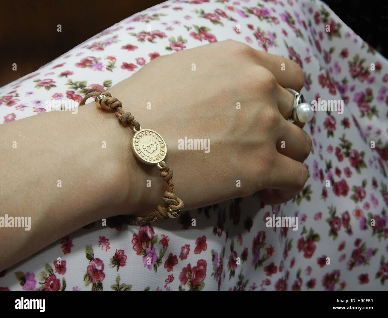 girl and hand with the coin bracelet Stock Photo - Alamy