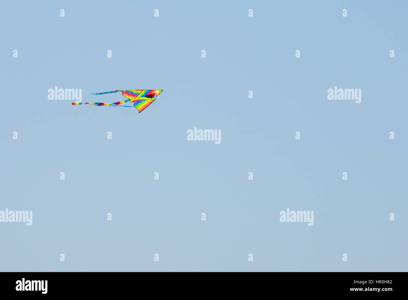 a nice multi color kite in the blue sky Stock Photo - Alamy