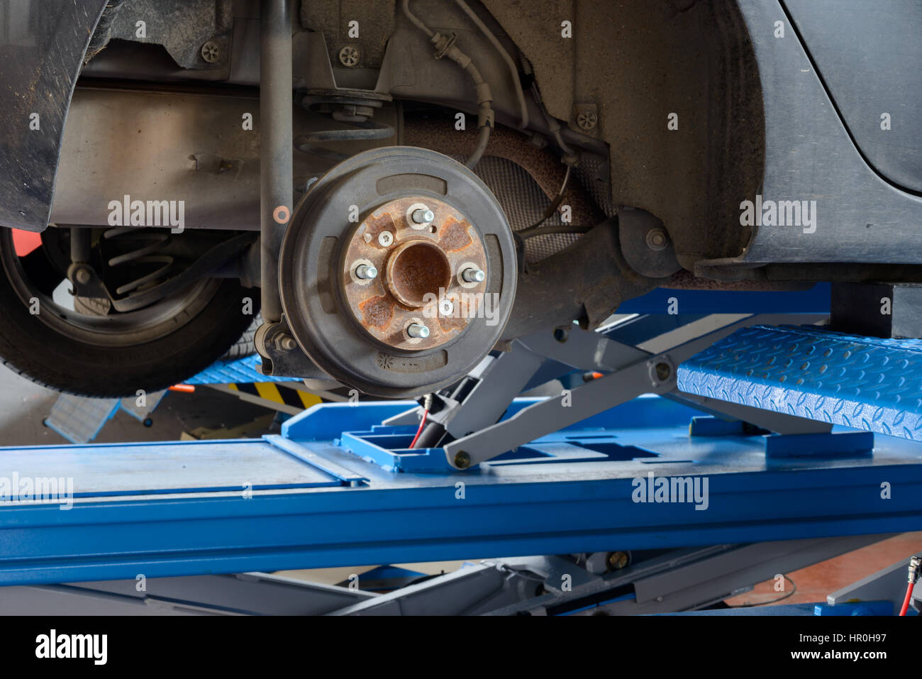 A car ready for fix on a workshop bridge, brakes are visible Stock ...