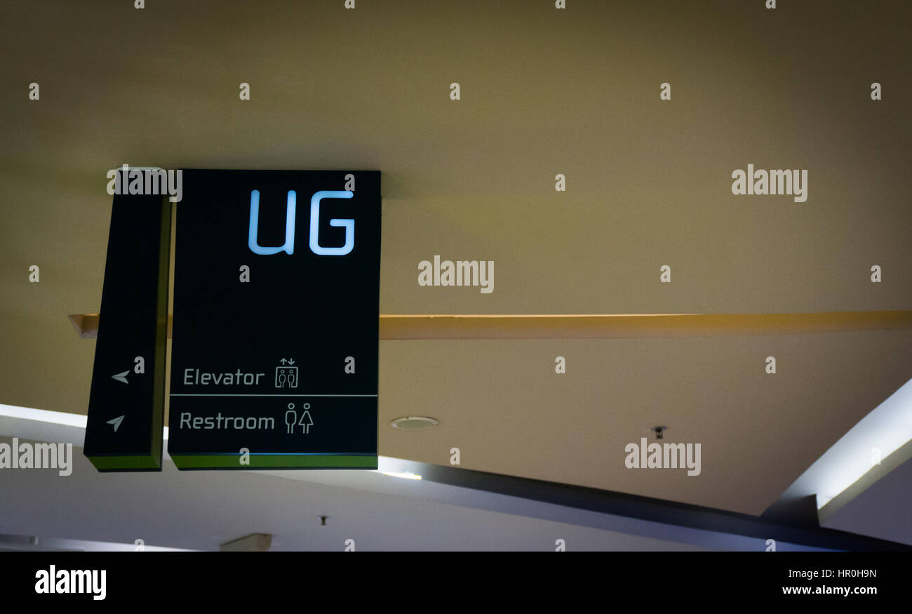 A sign board to UG - Upper Ground Floor hanging on ceiling at Central ...