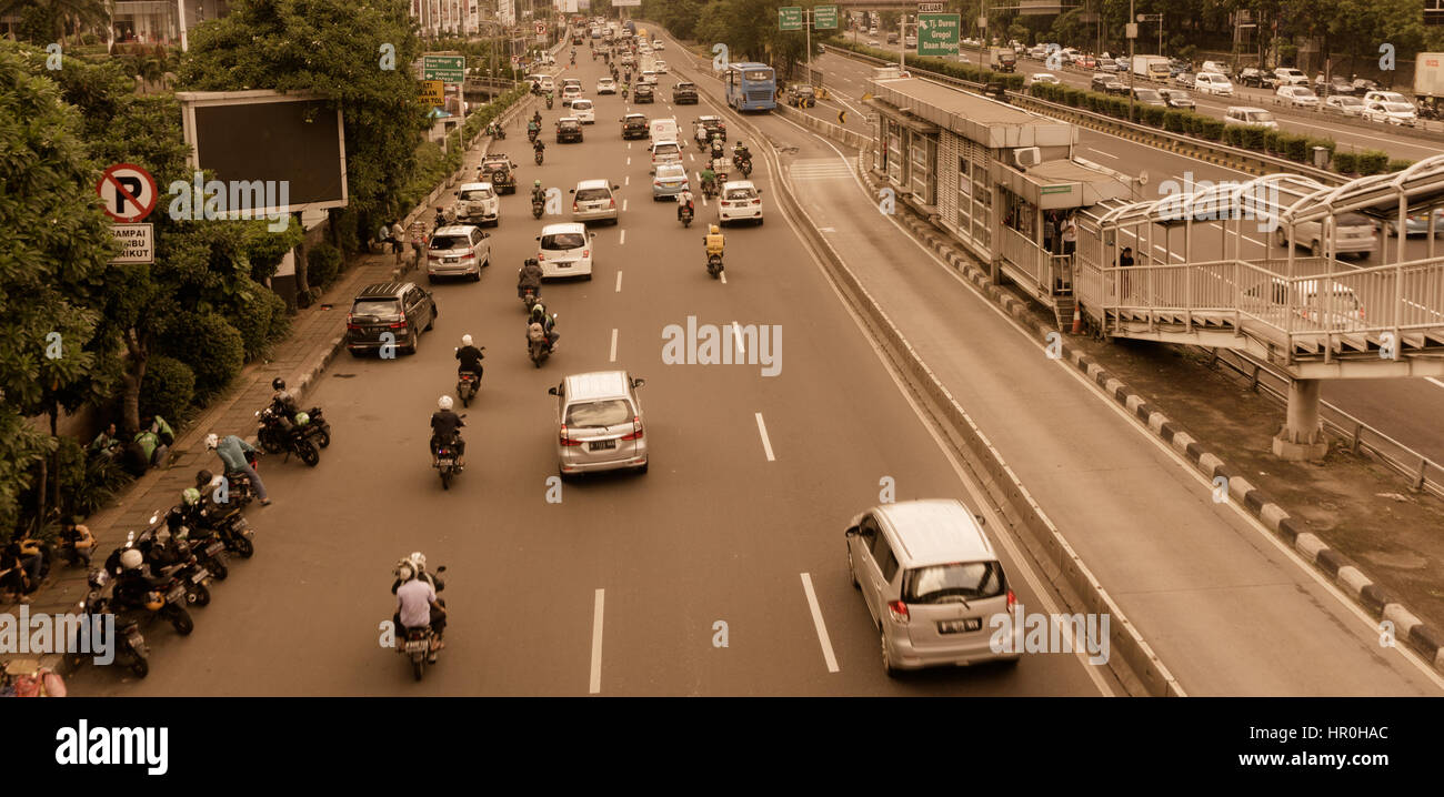 traffic in Jakarta City main street with Busway path in the middle ...