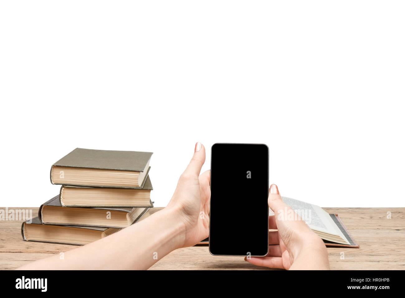 Female hand holding a smartphone with a black screen next to book lying ...