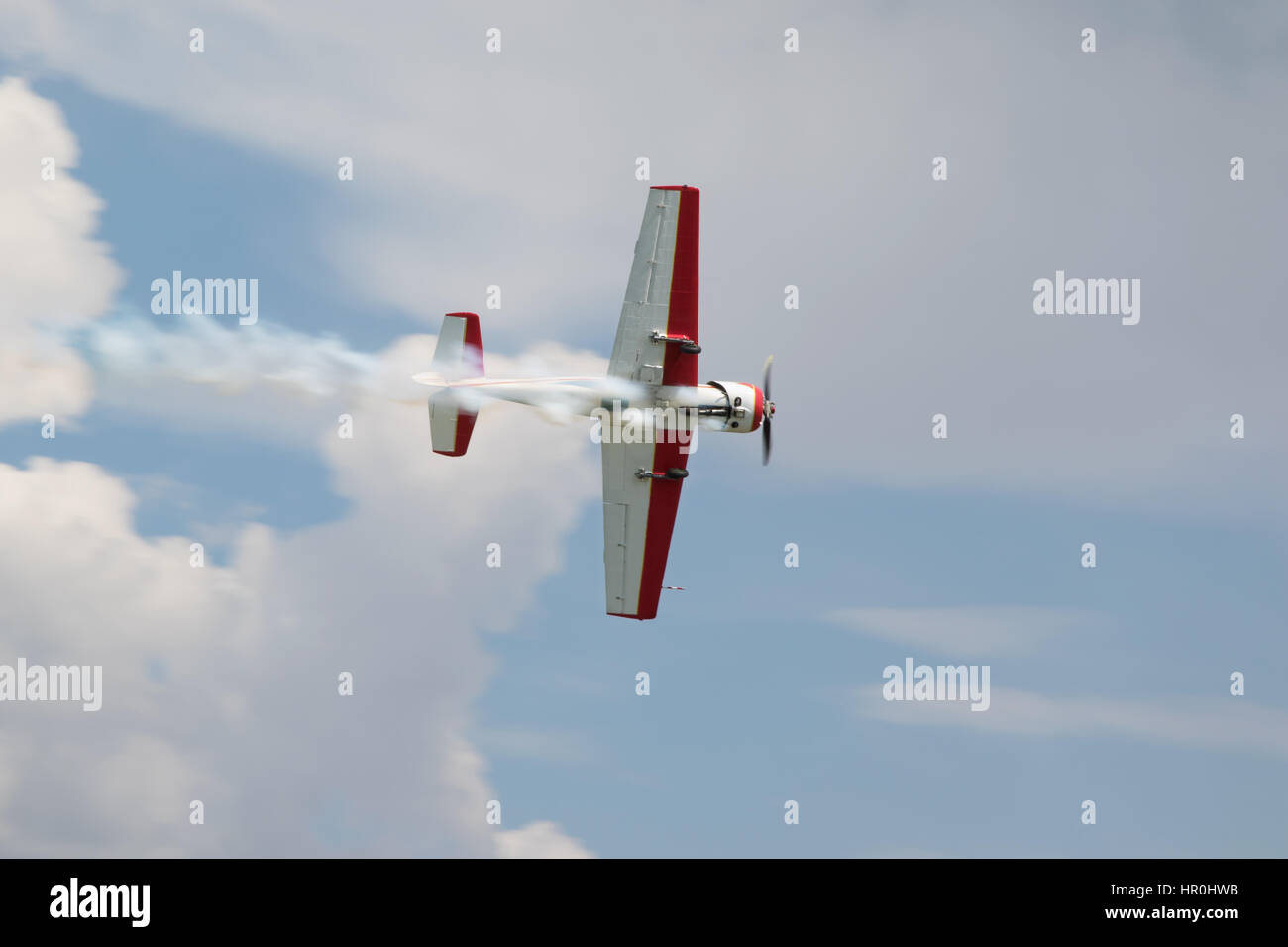 Red - white plane jets of smoke in flight in a blue sky close-up Stock ...