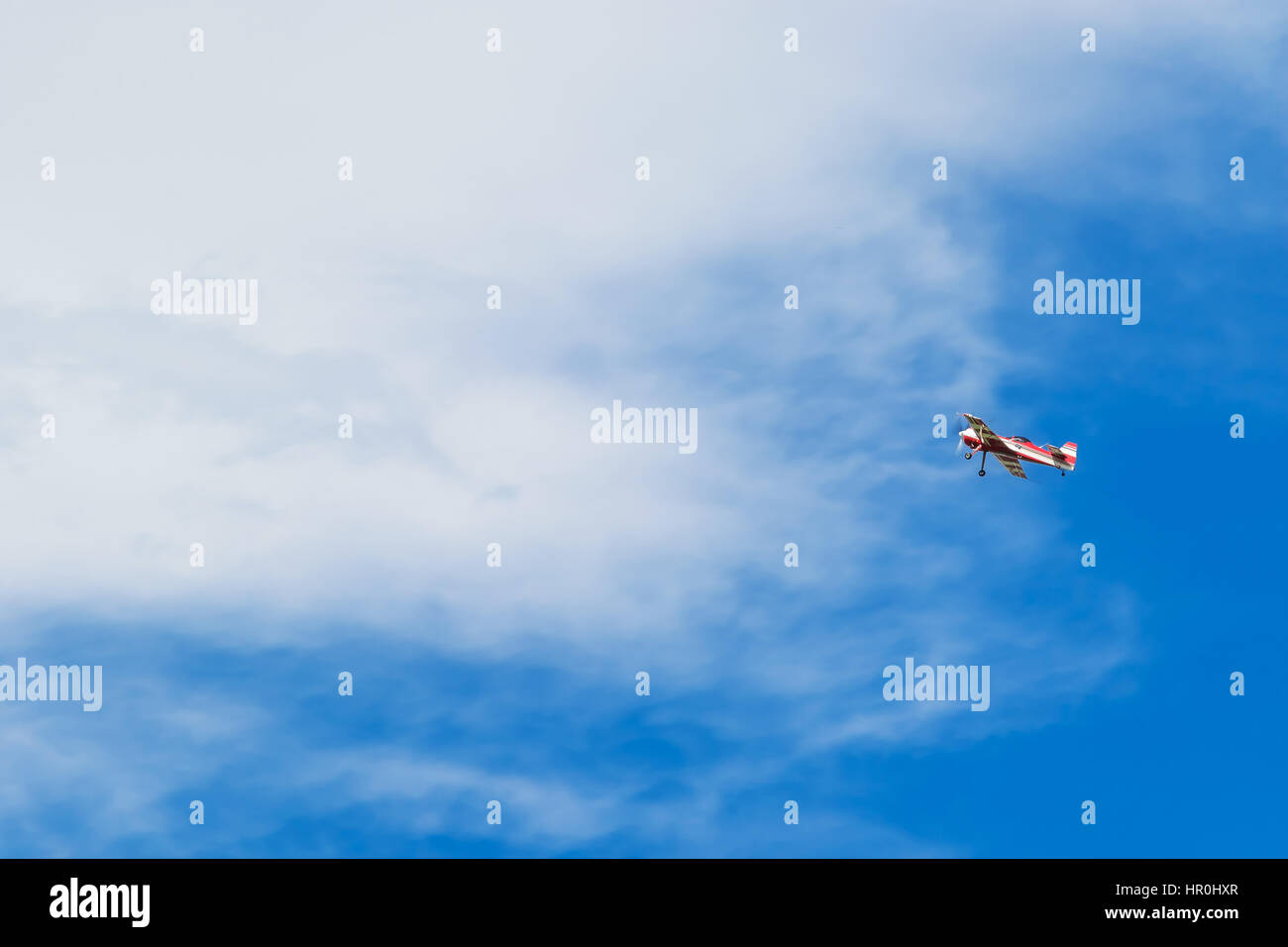 Red and white striped airplane flying in the beautiful blue sky Stock ...