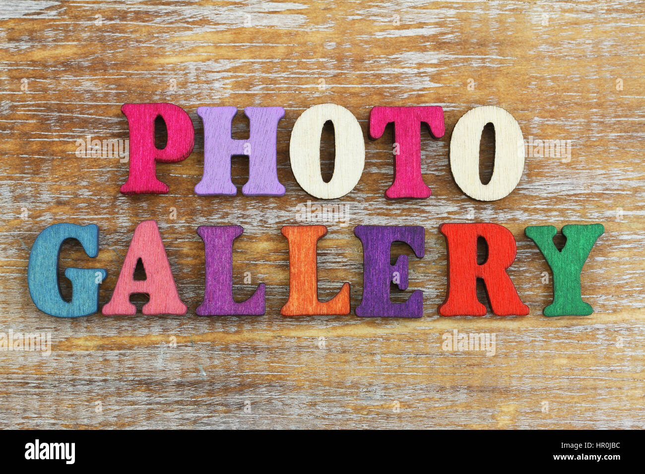 Photo gallery written with colorful letters on rustic wooden surface ...