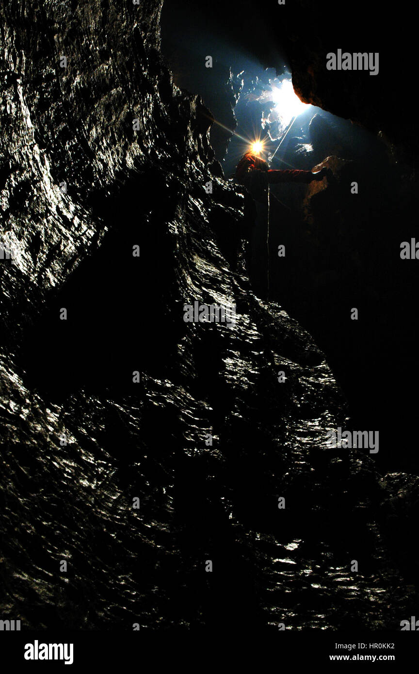 Caver descends in a cave on a rope Stock Photo - Alamy