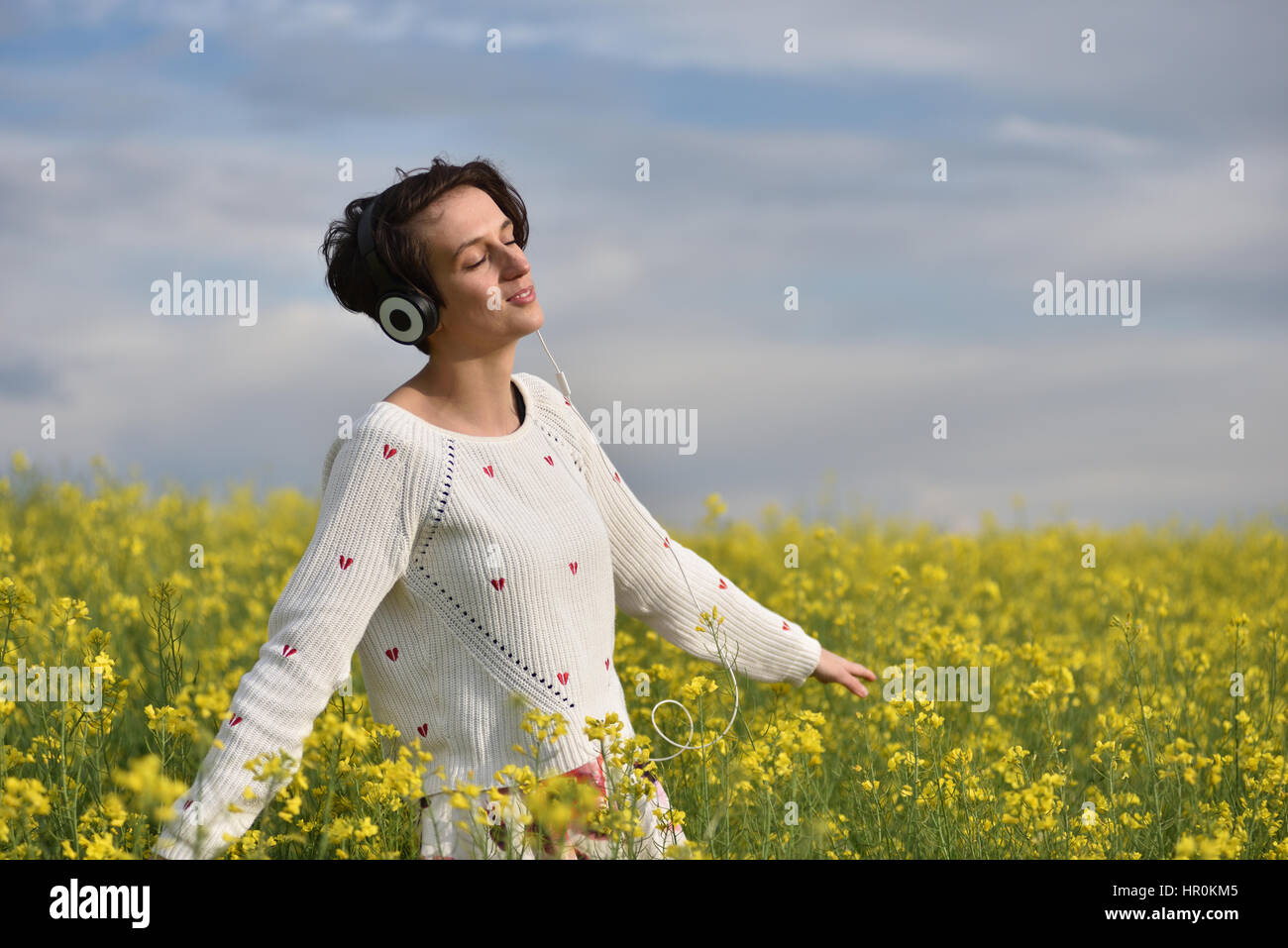 Young woman enjoying music in the headphones in the outdoors Stock ...
