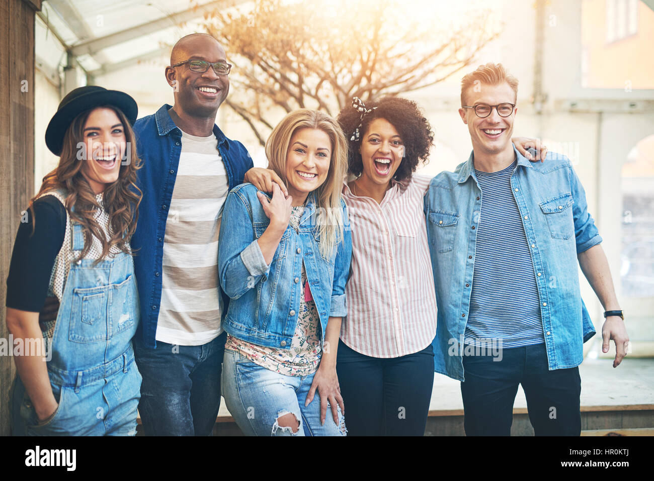 Group of beautiful young people in casual wear standing close together ...