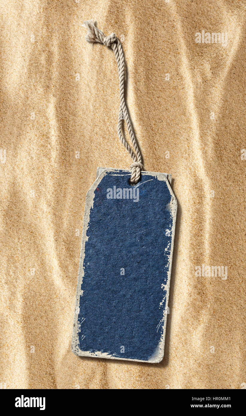 Blue blank paper label on sand background Stock Photo - Alamy