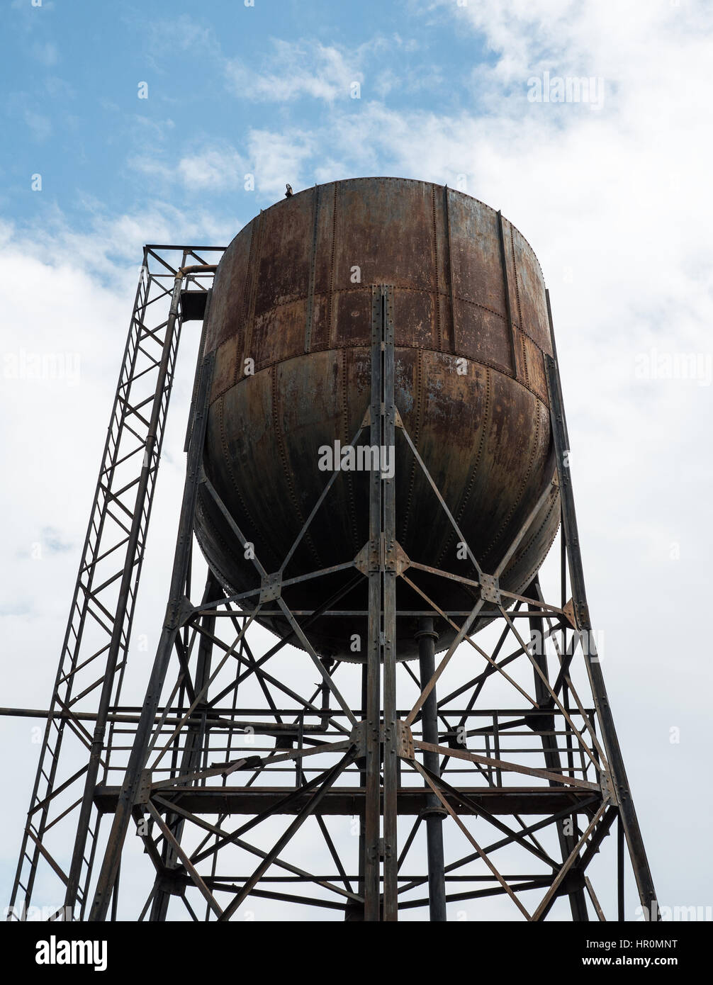 Old water tower with the metal structure of the old factory Stock Photo ...