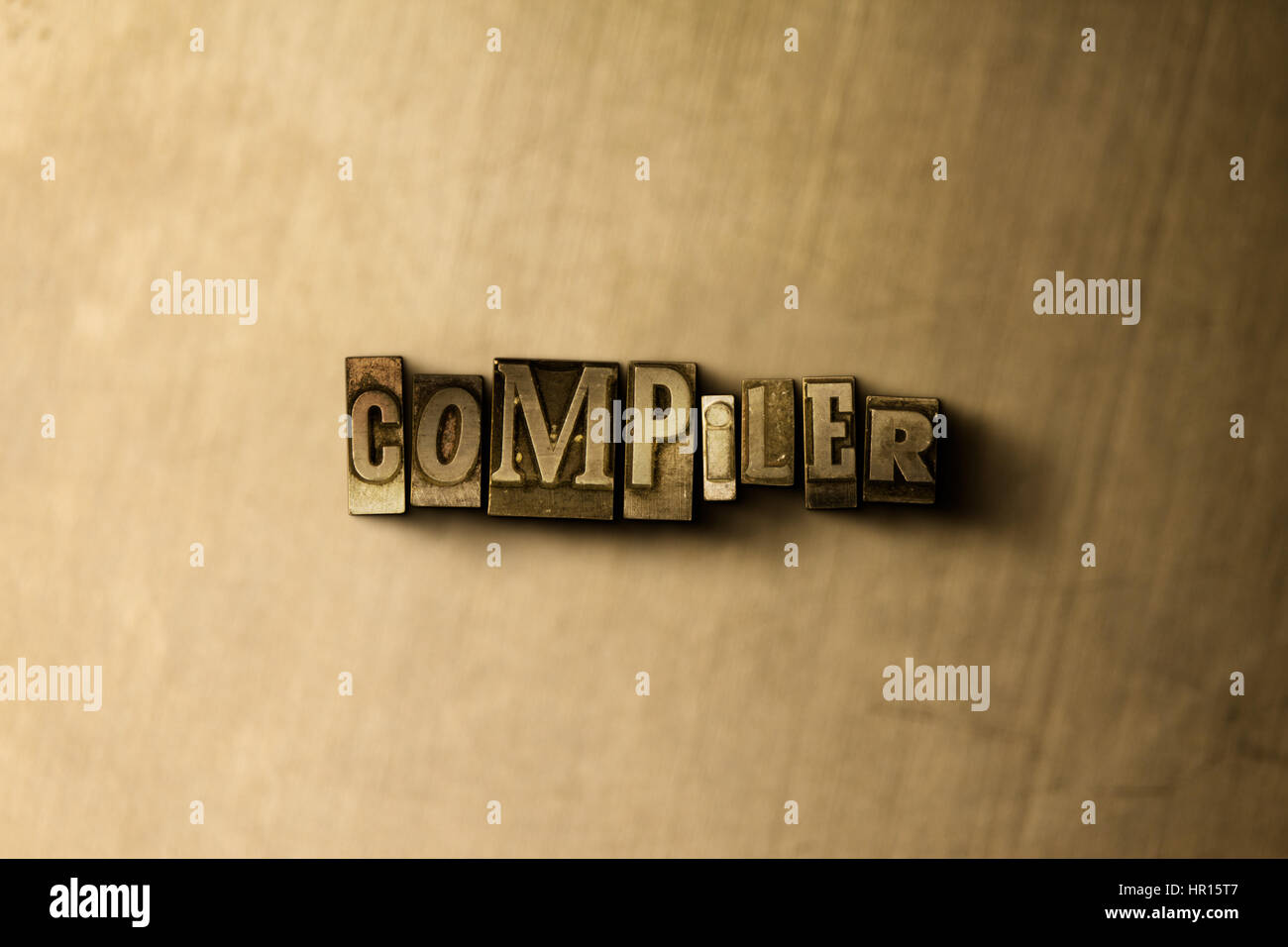 COMPILER - close-up of grungy vintage typeset word on metal backdrop ...