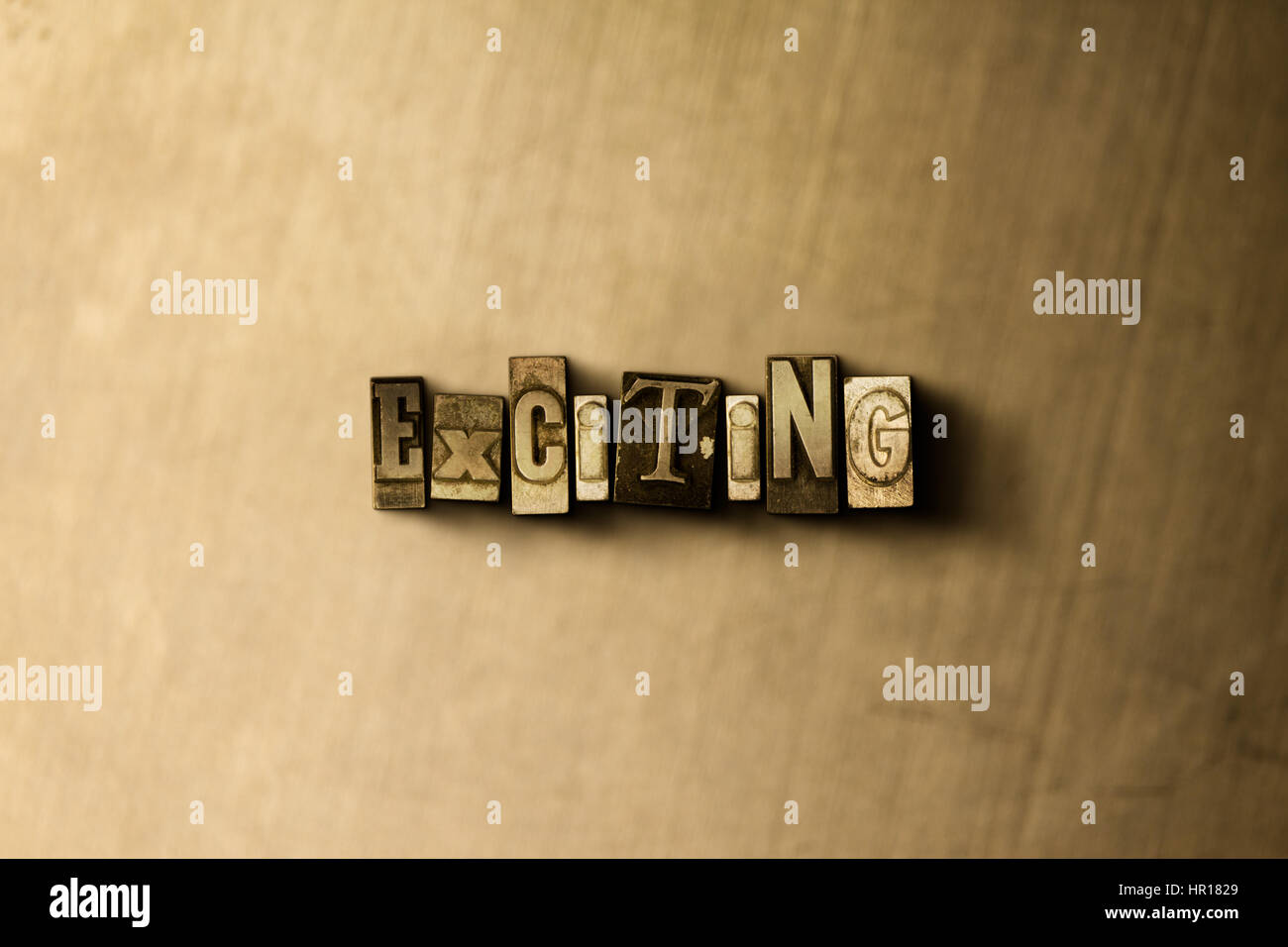 EXCITING - close-up of grungy vintage typeset word on metal backdrop ...