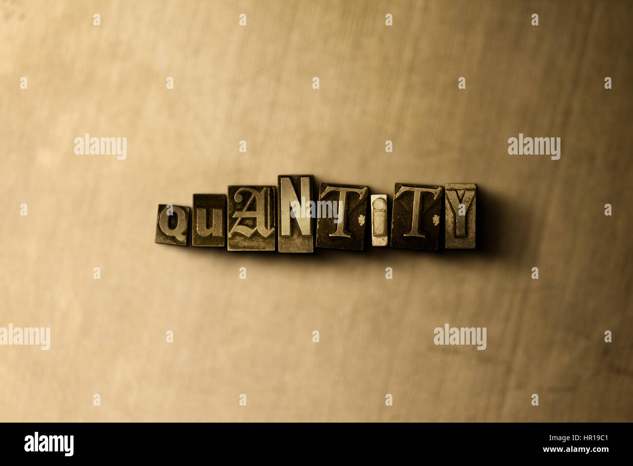 QUANTITY - close-up of grungy vintage typeset word on metal backdrop ...