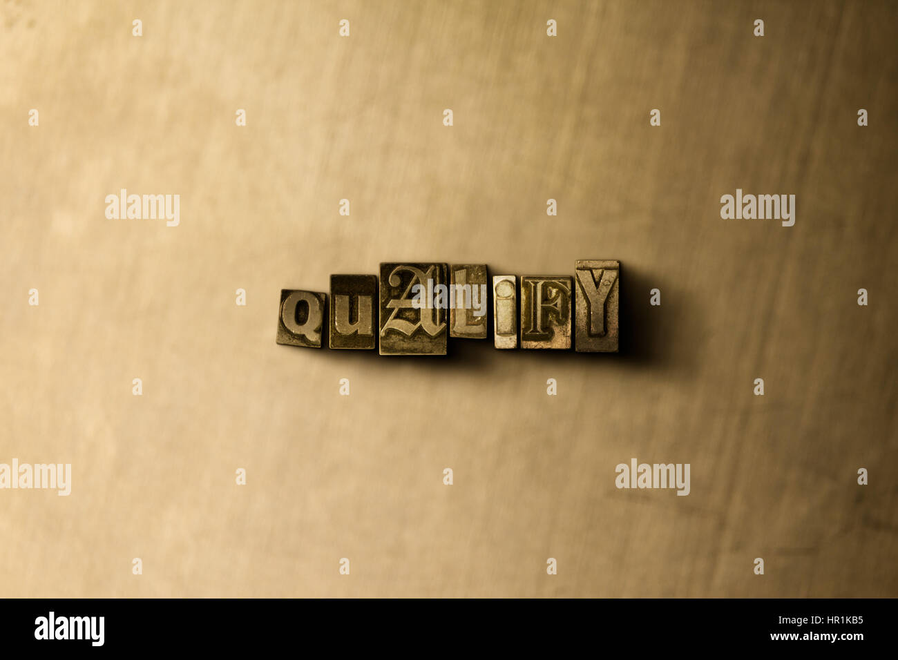 QUALIFY - close-up of grungy vintage typeset word on metal backdrop ...