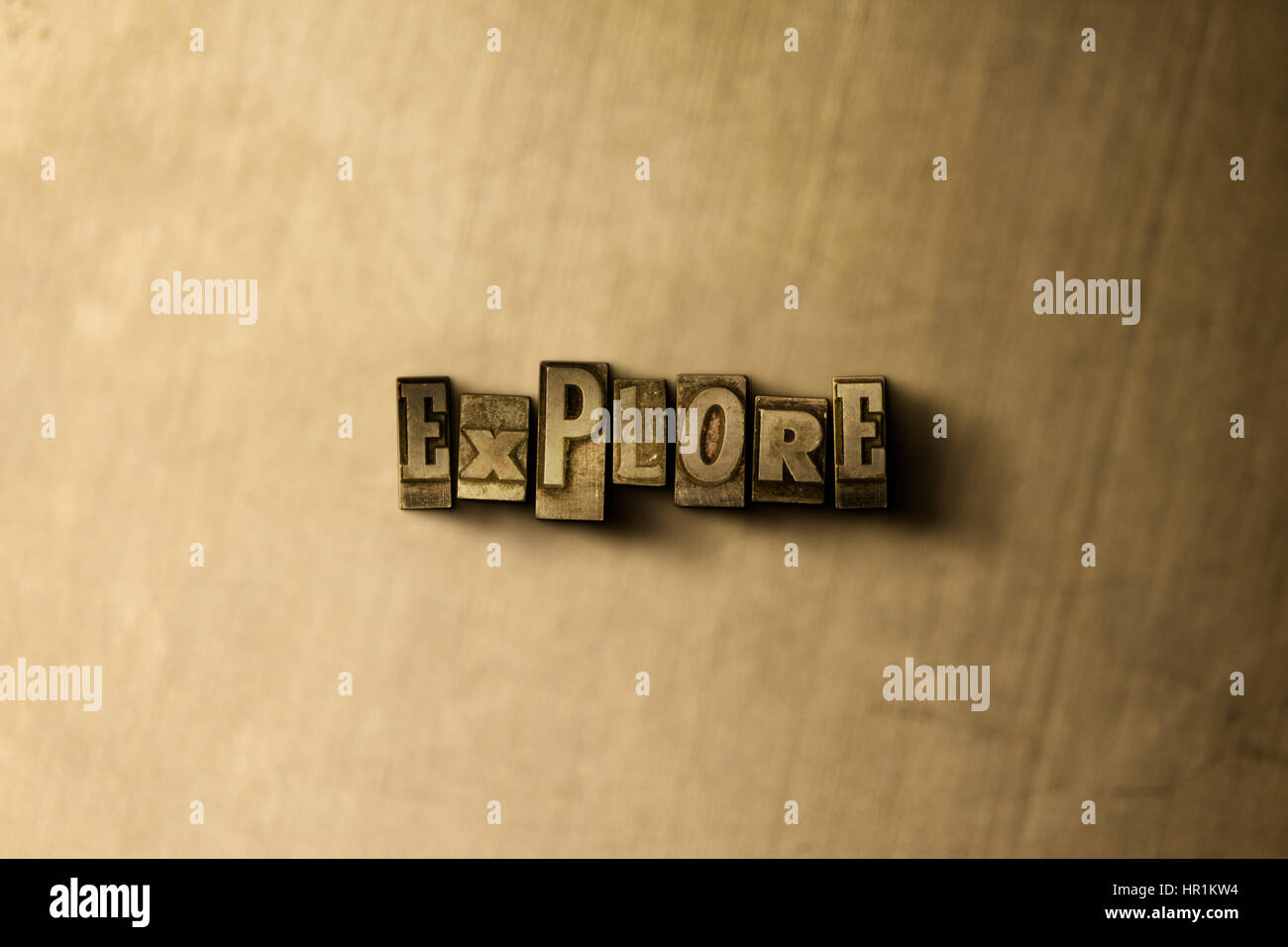 EXPLORE - close-up of grungy vintage typeset word on metal backdrop ...