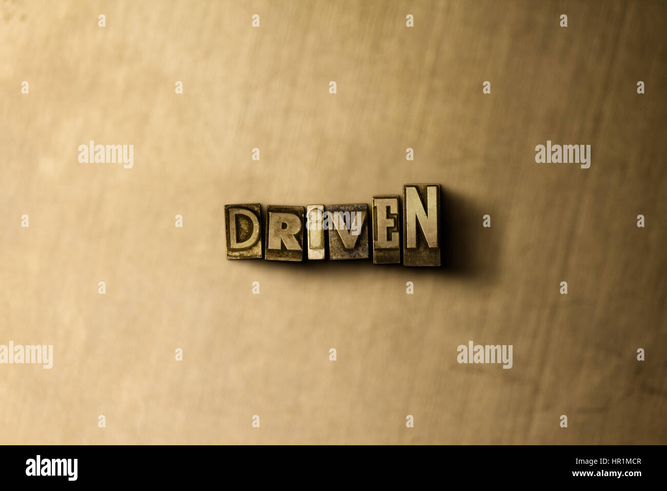 DRIVEN - close-up of grungy vintage typeset word on metal backdrop ...