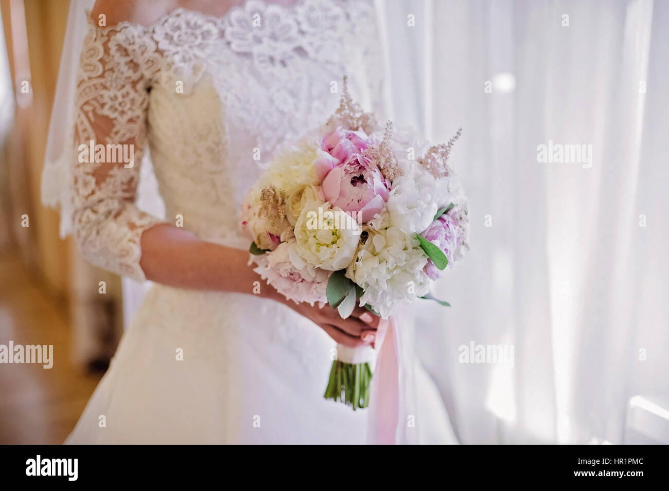 Bride holding delicate marriage bouquet Stock Photo - Alamy