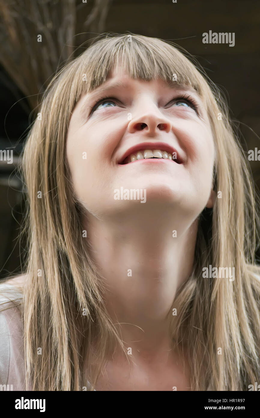 Image of beautiful blond woman looking upwards Stock Photo - Alamy