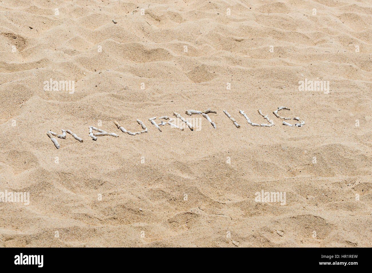 Mauritius inscription in the sand lined with coral. Closeup picture of ...