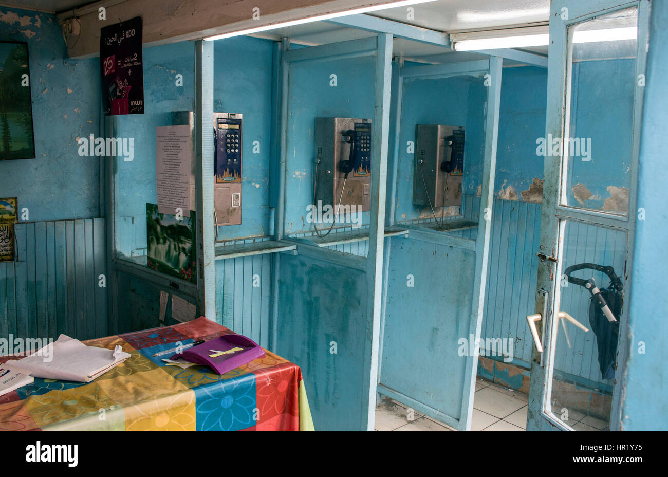 Three public telephone cabins separated with wooden planks in ...