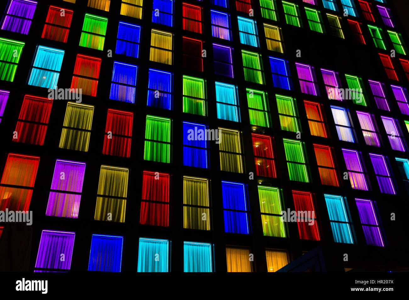 Colored windows texture. Windows illuminated by neon lights background ...