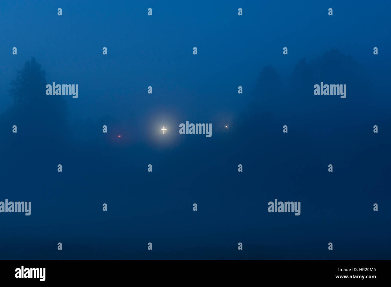 White neon lighted cross in early morning fog Stock Photo - Alamy