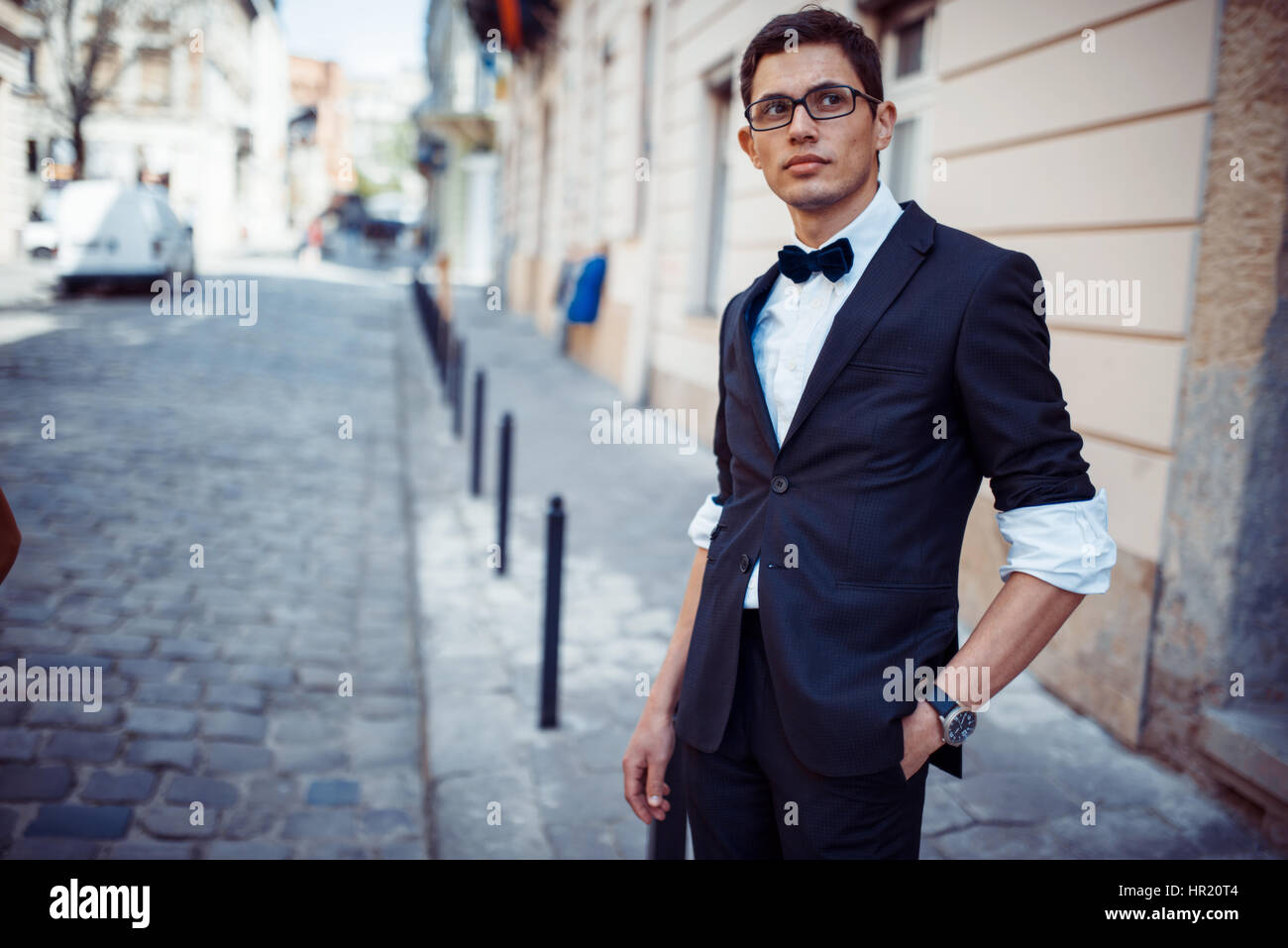 Portrait of fashionable well dressed man posing outdoors looking away ...