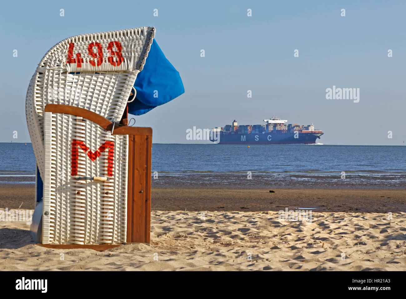 Container ship in the Wadden Sea, roofed wicker beach chair, Cuxhaven ...