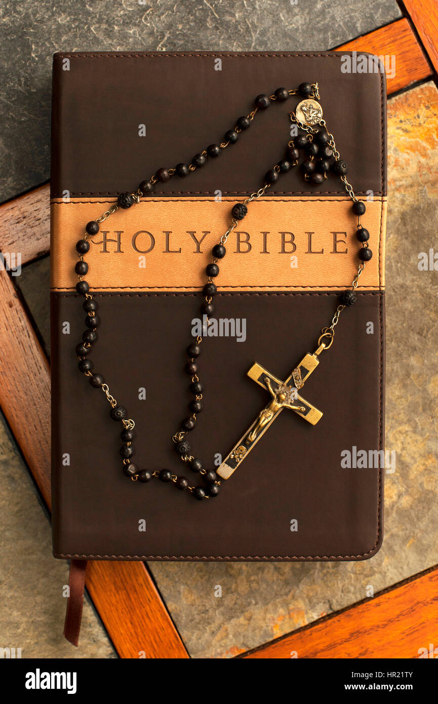 Holy Bible on table with rosary Stock Photo - Alamy