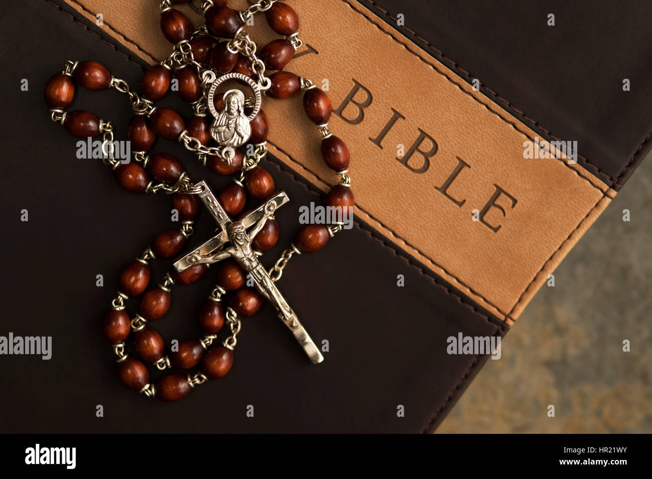 Holy Bible on table with rosary Stock Photo - Alamy