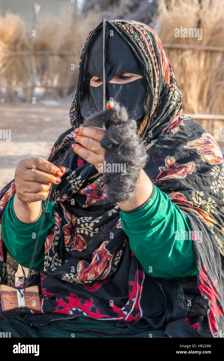 Muscat, Oman - Feb 4, 2017: An old Omani woman dressed in a traditional ...