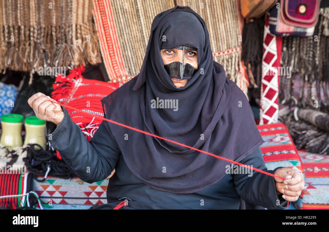 Muscat, Oman - Feb 4, 2017: An old Omani woman dressed in a traditional ...