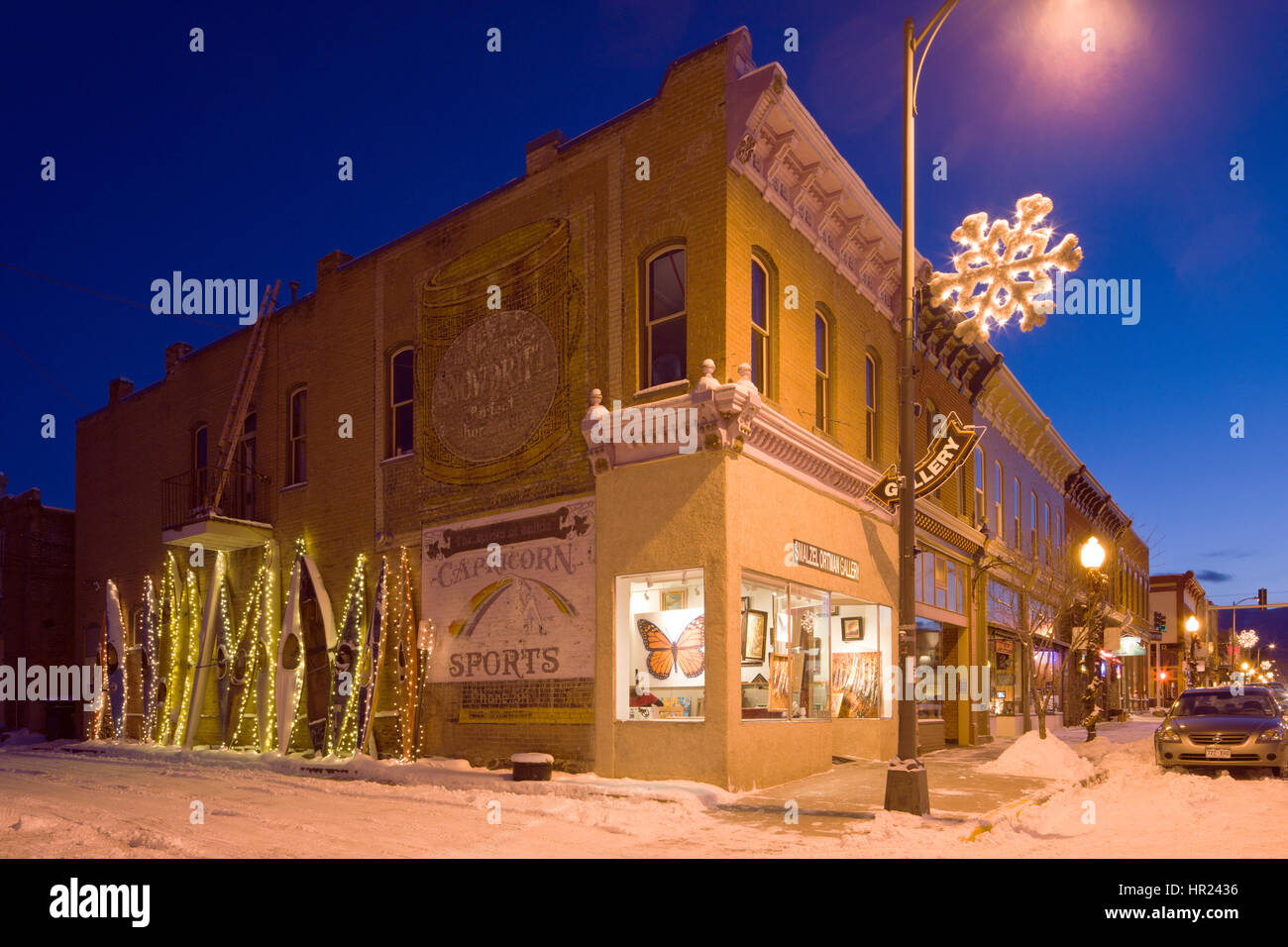 Dusk view of holiday lights illuminate colorful kayaks along a historic ...
