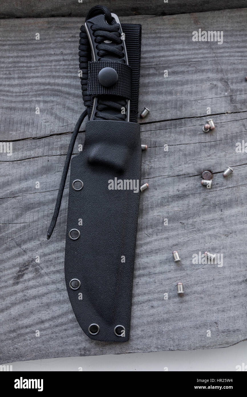 The hunting knife in a cover. The vertical position Stock Photo - Alamy