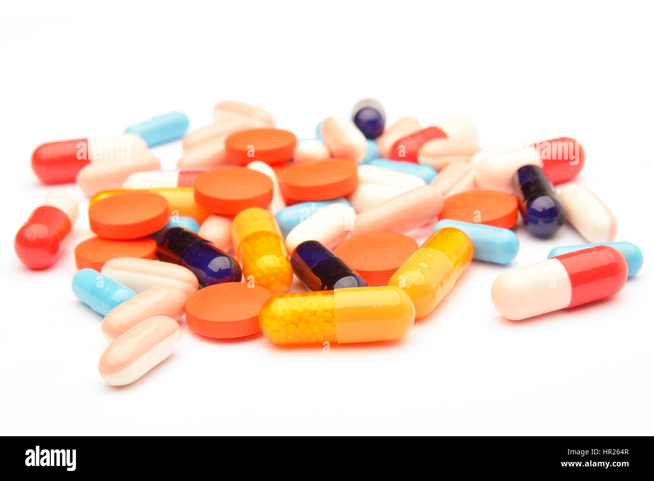 Colored pills, tablets and capsules on a white background Stock Photo ...