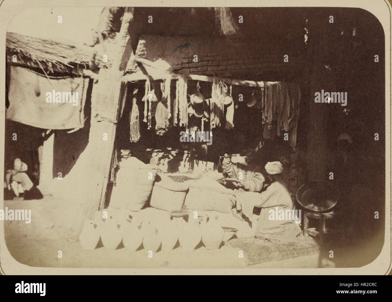 'Peddling. A Stall' is a depiction of a busy street scene, showing a ...