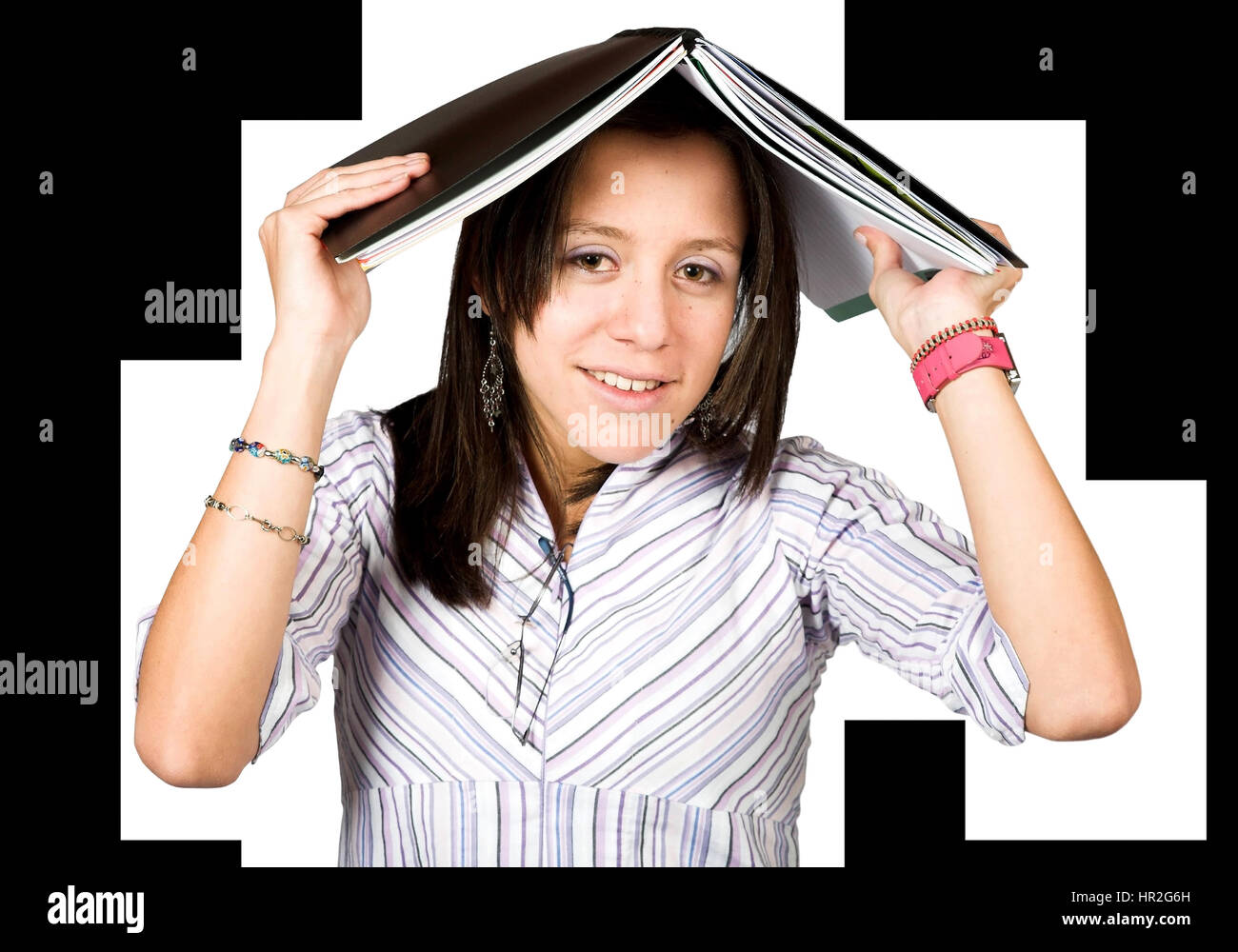 female student with book on head over white Stock Photo - Alamy