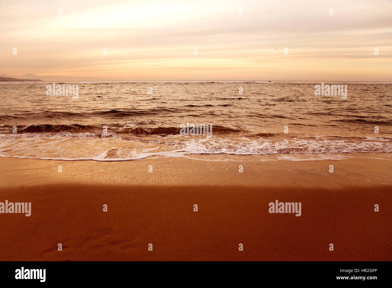 beautiful sunset by the beach in orange colours Stock Photo - Alamy