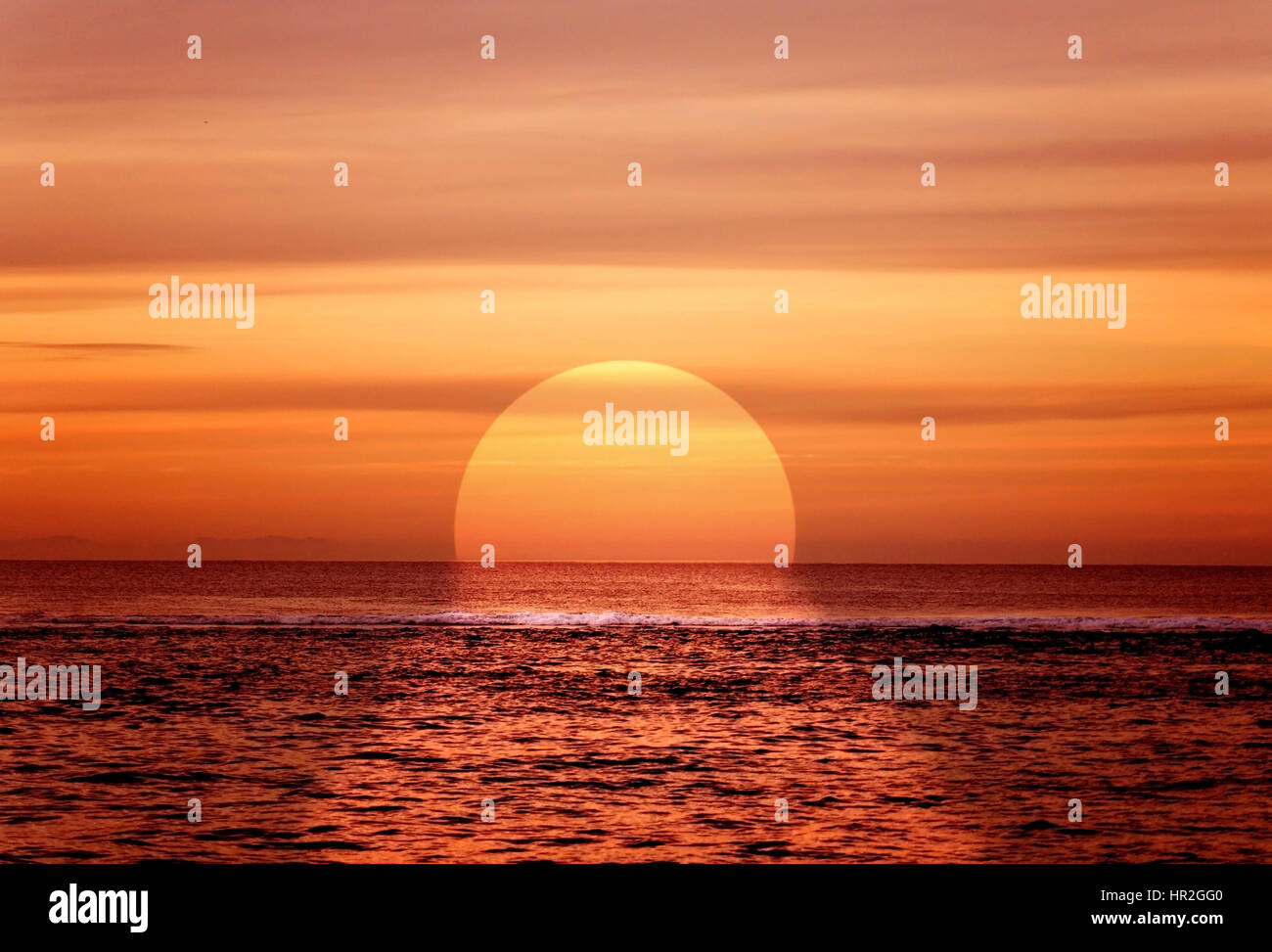 beautiful sunset by the beach in orange colours Stock Photo - Alamy