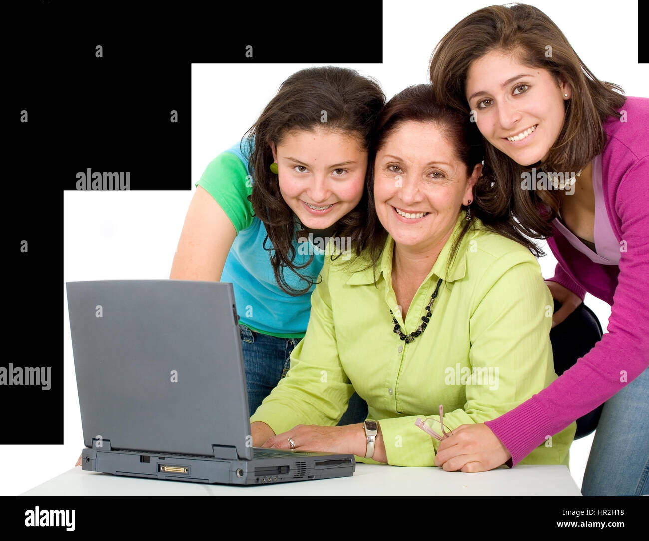 family on a laptop computer smiling - isolated over a white background ...